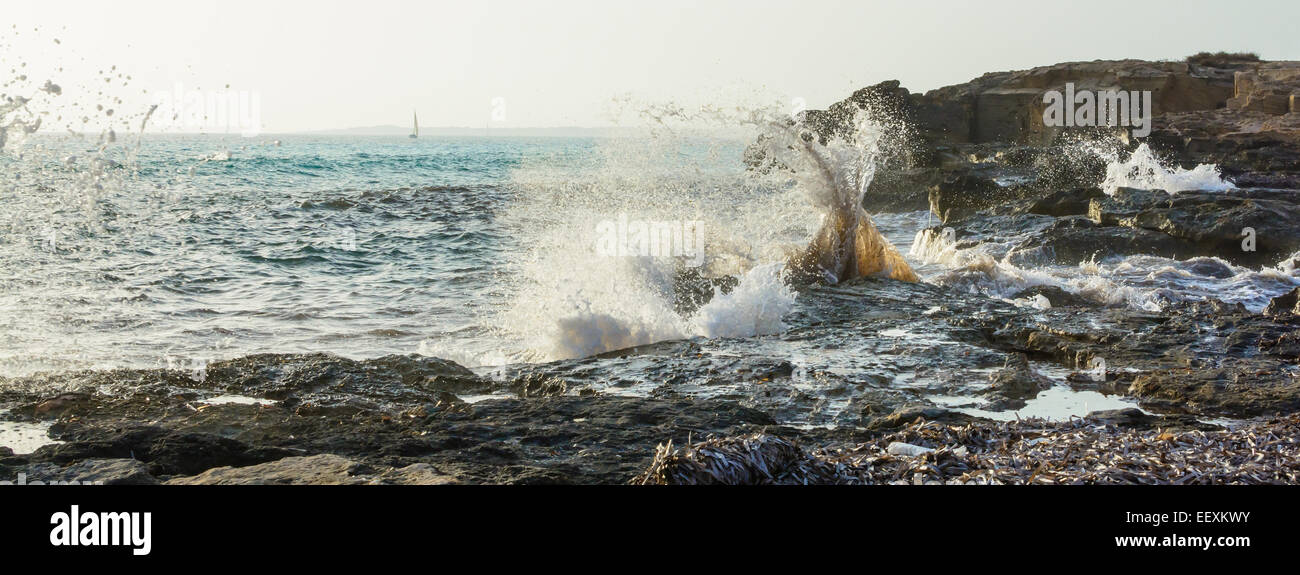 Panoramic wave battery and sailboat on Mediterranean coast in Majorca ...