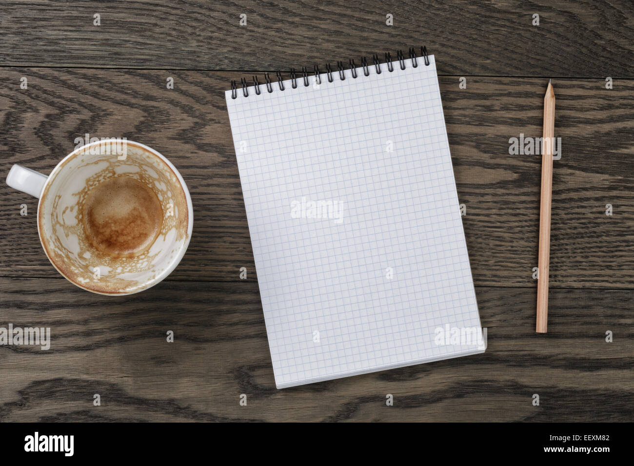Blank notepad with pencil and empty coffee cup on wooden table, office ...