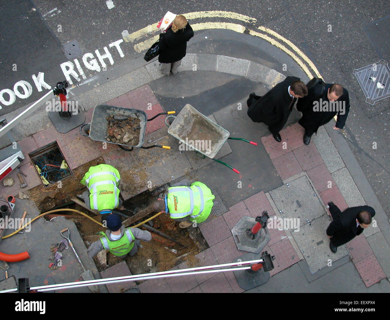 Laying cables under paving Murphy Cable layers Workmen digging up road ...