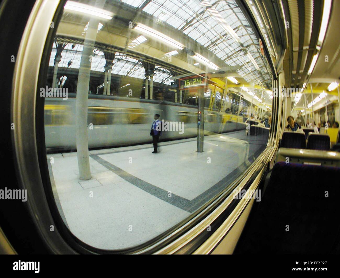 commuters view from train window with guard watching train leave ...