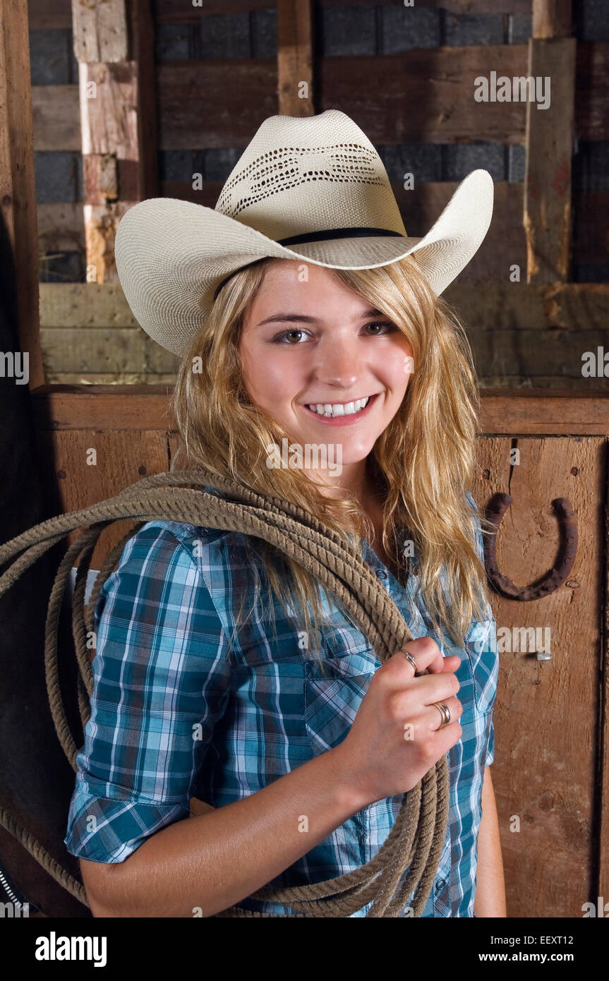 Woman in a stable with rope Stock Photo - Alamy