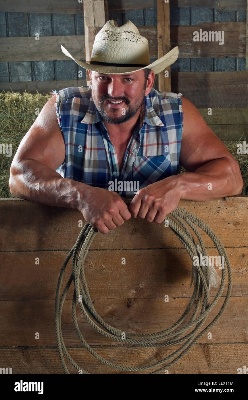 Man in a stable with a rope Stock Photo - Alamy