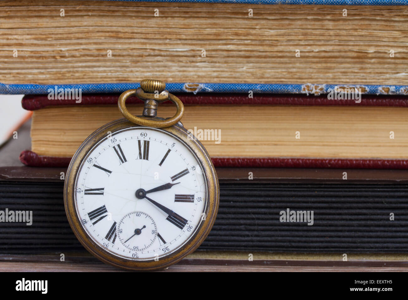 antique clock on books background Stock Photo - Alamy