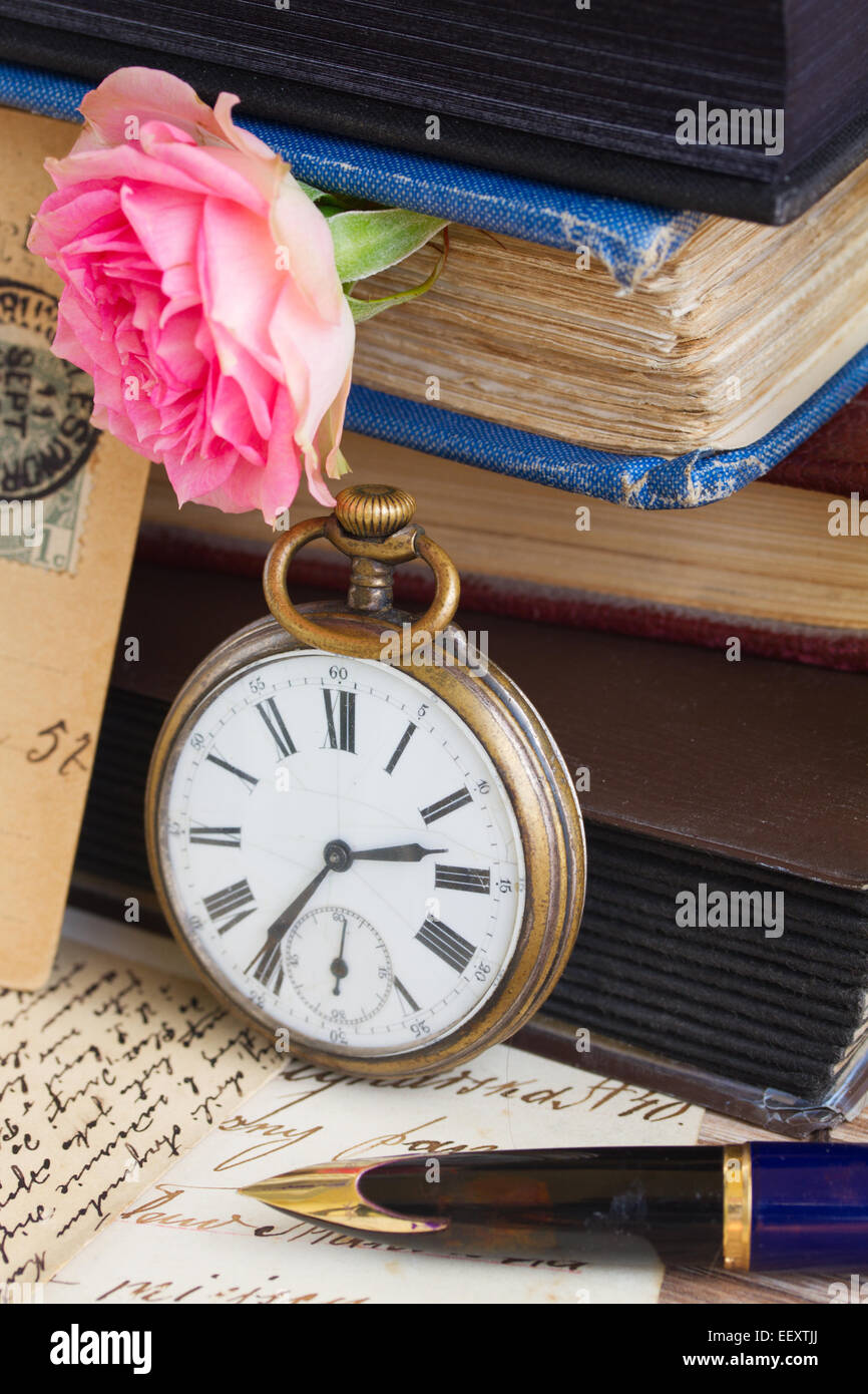 antique clock on old books and letters background Stock Photo - Alamy