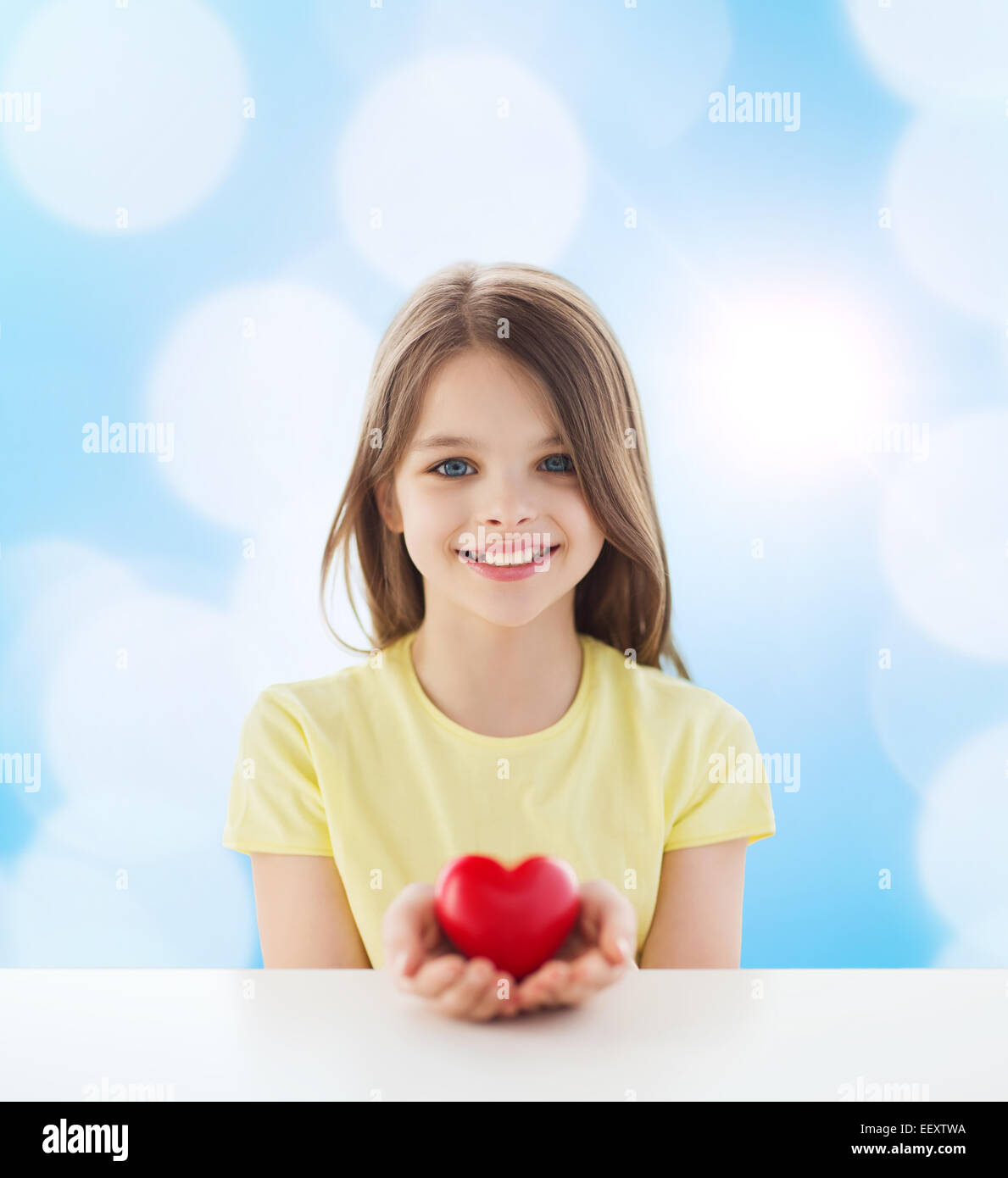 beautiful little girl sitting at table Stock Photo - Alamy