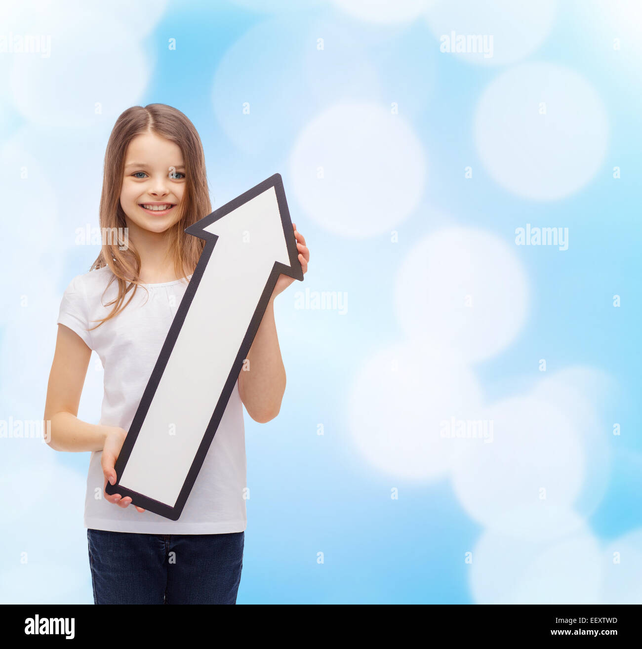 smiling little girl with blank arrow pointing up Stock Photo - Alamy
