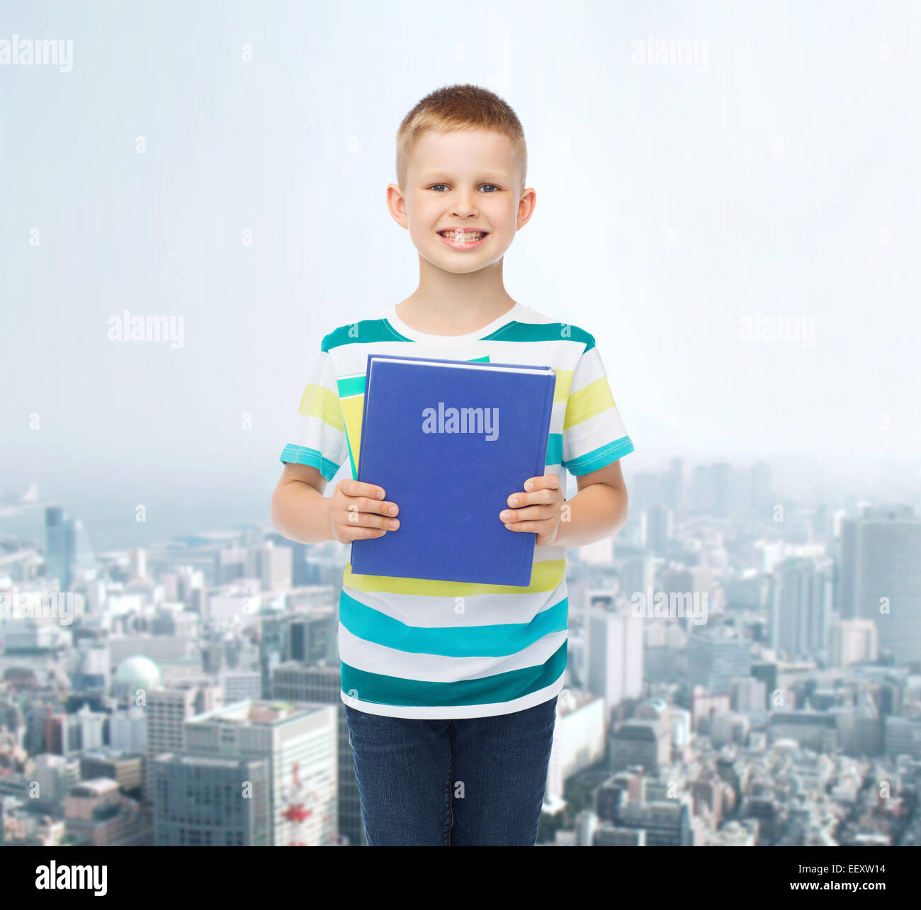smiling little student boy with blue book Stock Photo - Alamy