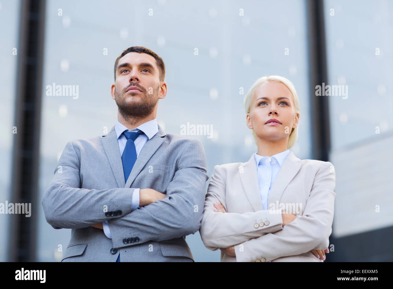 serious businessmen standing over office building Stock Photo - Alamy
