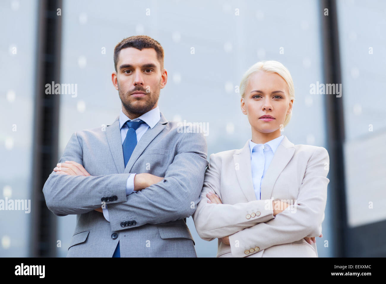serious businessmen standing over office building Stock Photo - Alamy