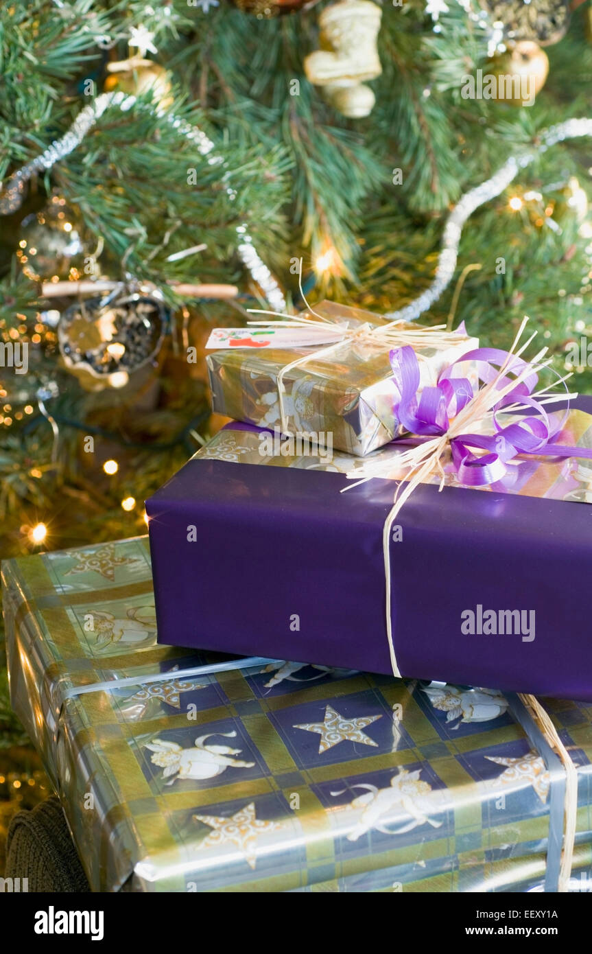Presents by a Christmas tree Stock Photo - Alamy