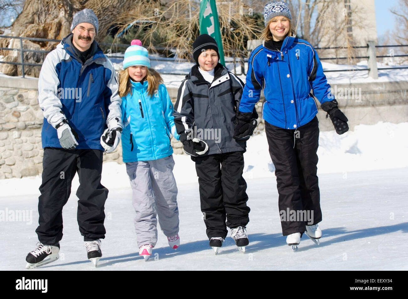 Family ice skating outdoors in winter together Stock Photo - Alamy