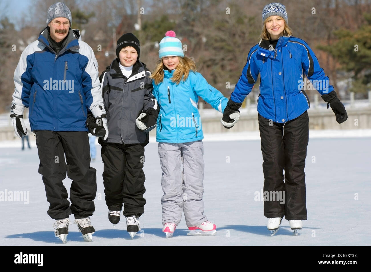 Family ice skating outdoors in winter together Stock Photo - Alamy