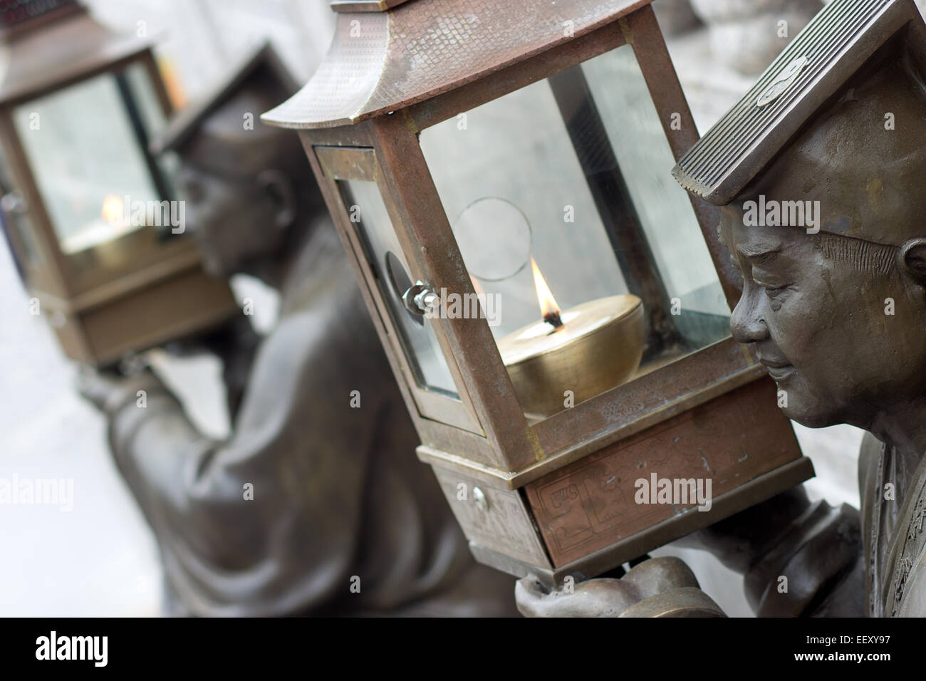 statues holding a lantern with holes for ignition incense sticks Stock ...