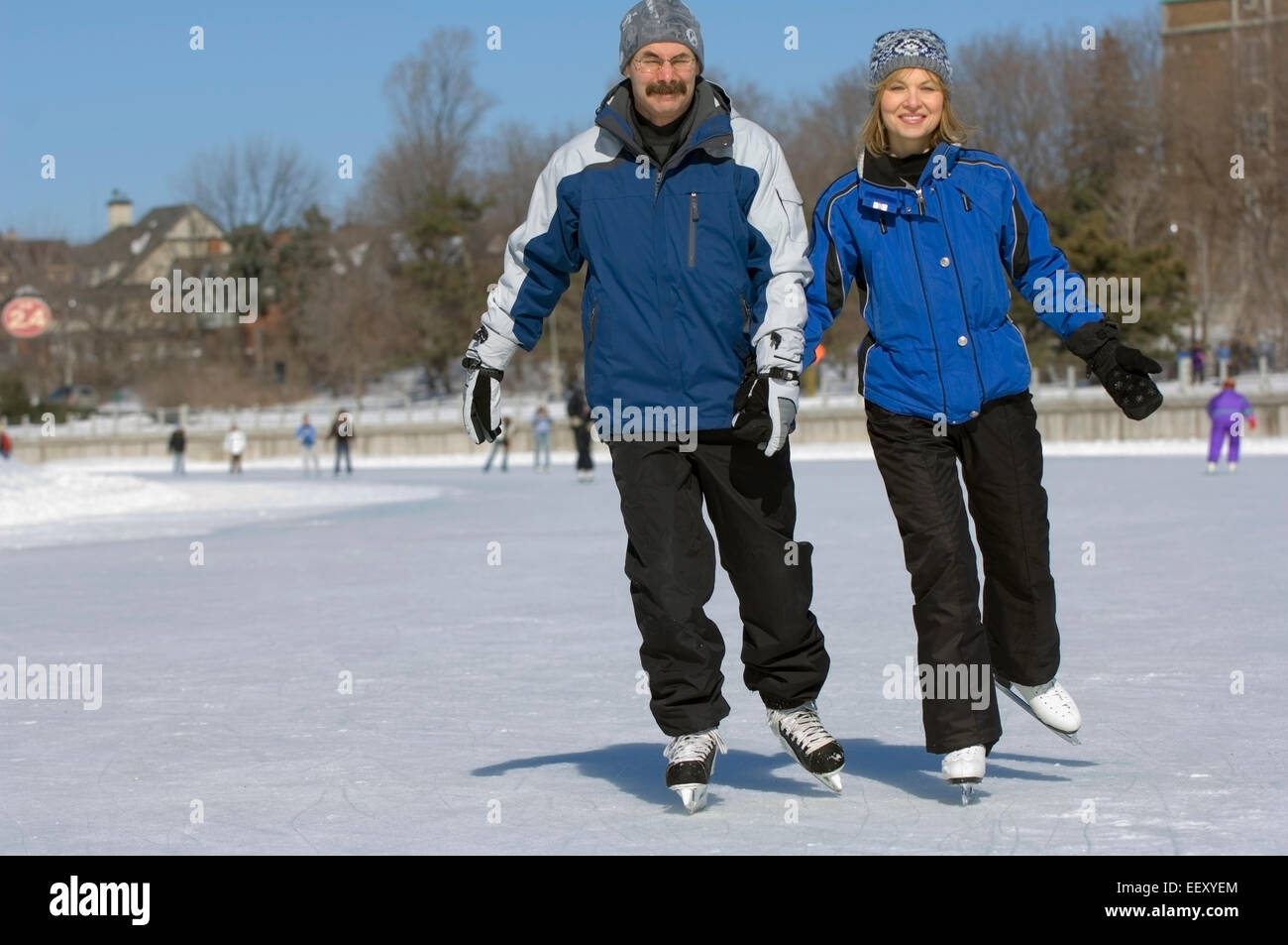 Couple ice skating outdoors together Stock Photo - Alamy
