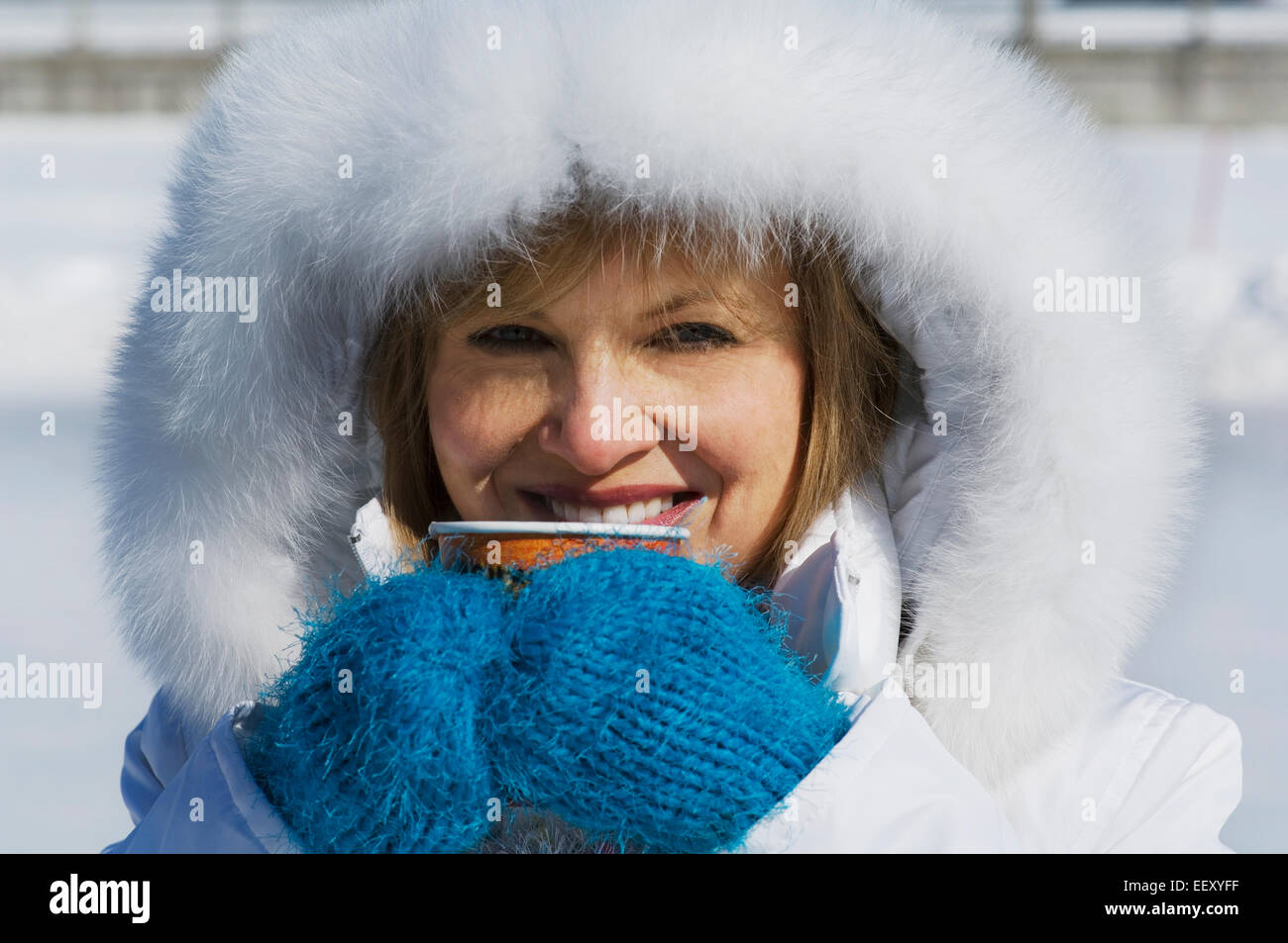 Woman outdoors in winter drinking hot beverage Stock Photo - Alamy