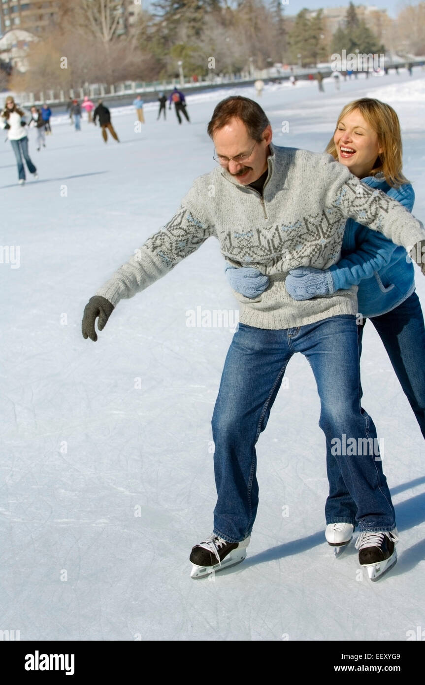 Couple ice skating outdoors together Stock Photo - Alamy