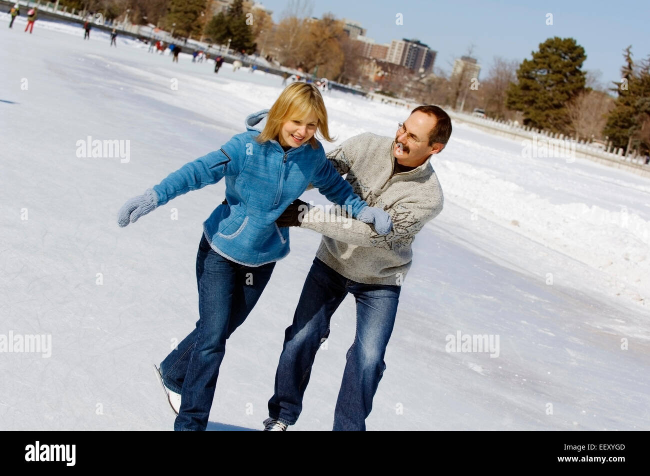 Couple ice skating outdoors together Stock Photo - Alamy