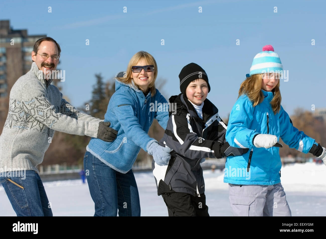 Family ice skating outdoors in winter together Stock Photo - Alamy
