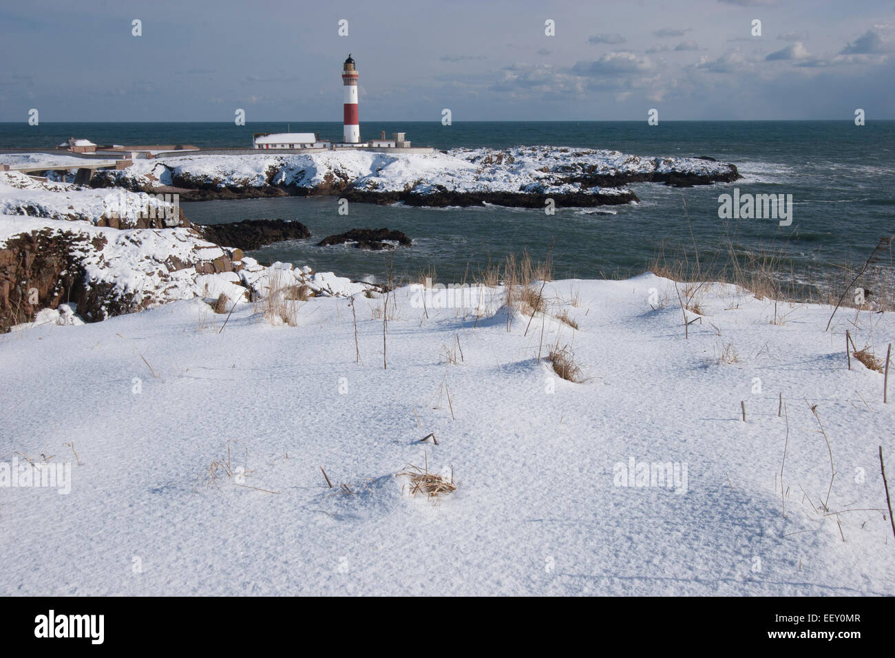Lighthouse in the snow Stock Photo - Alamy