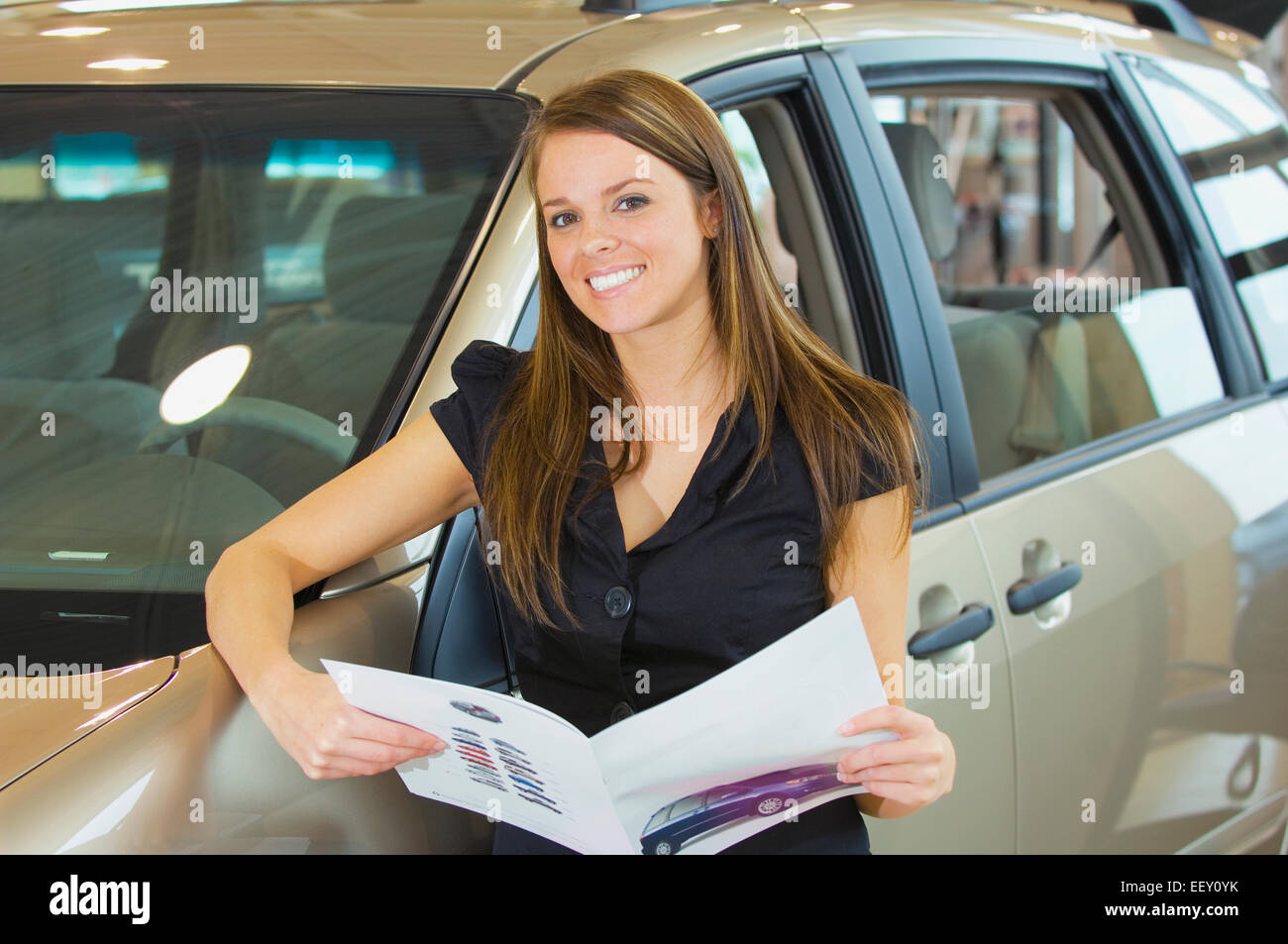 Woman at a car dealership Stock Photo - Alamy