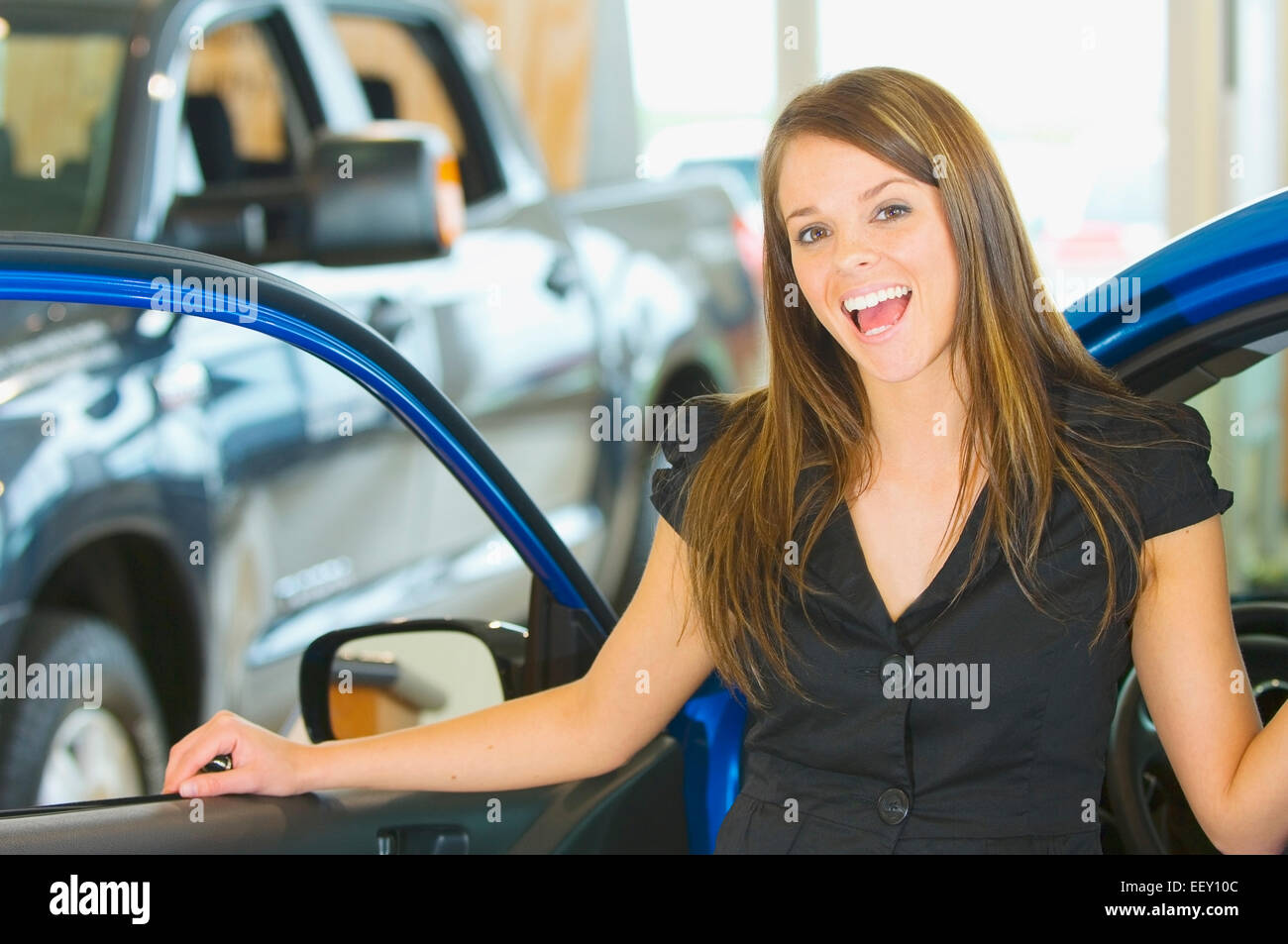 Woman at a car dealership Stock Photo - Alamy