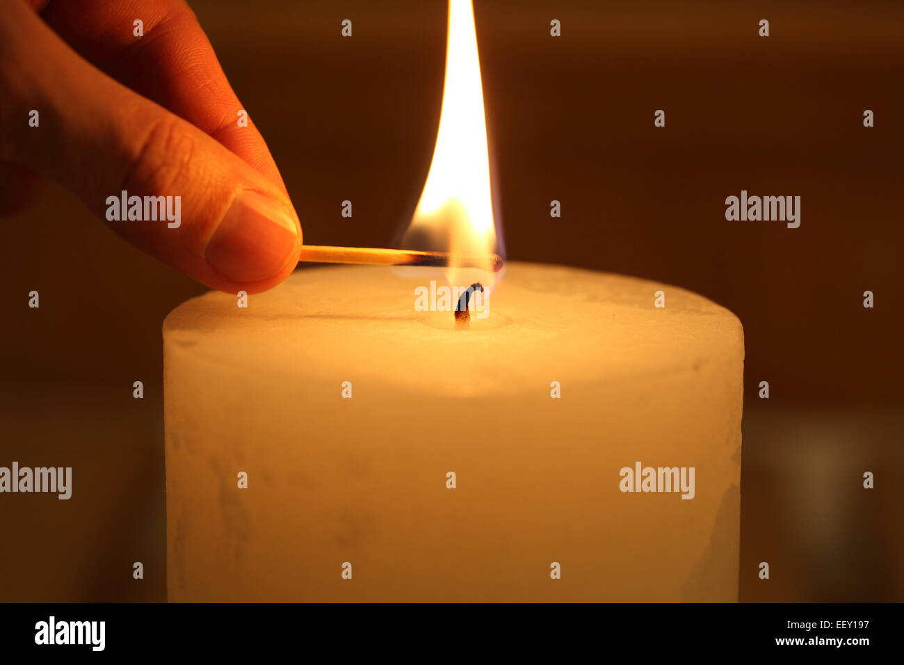 Hand lights match yellow candle hi-res stock photography and images - Alamy