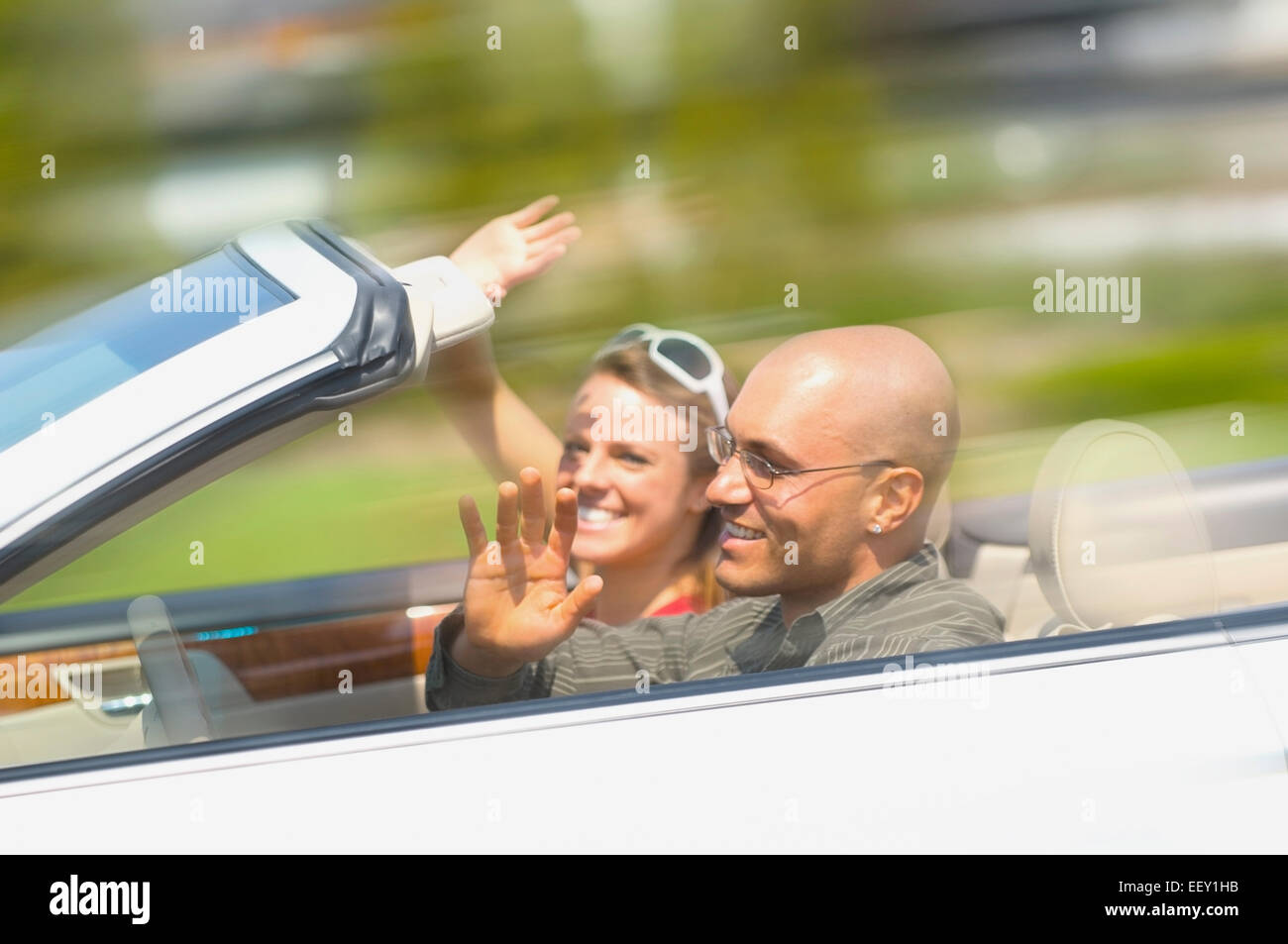 Couple in convertible Stock Photo - Alamy