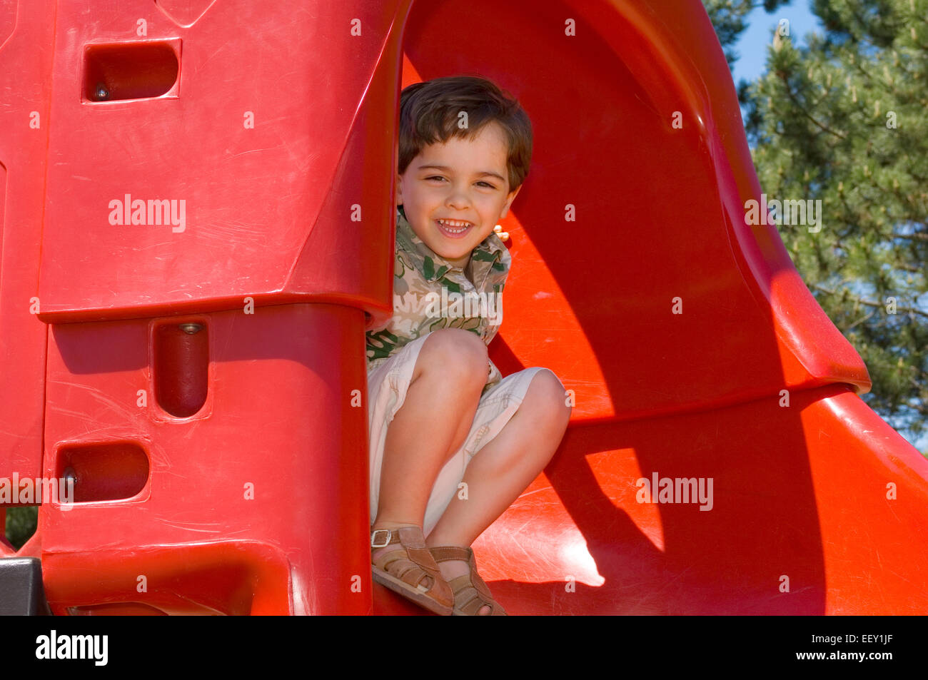 Young boy playing at playground Stock Photo - Alamy