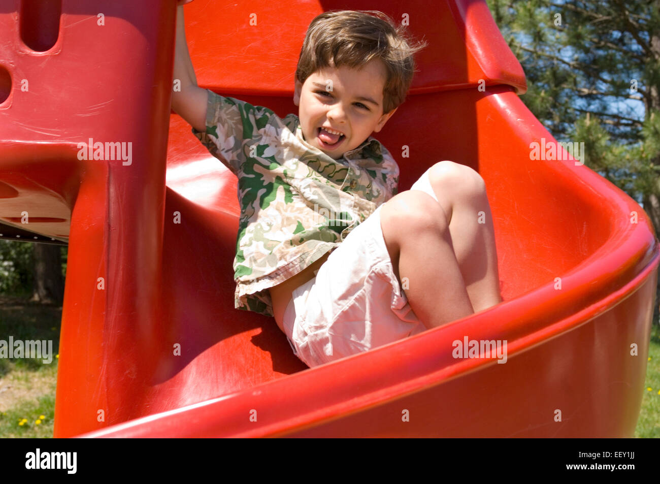 Young boy playing at playground Stock Photo - Alamy