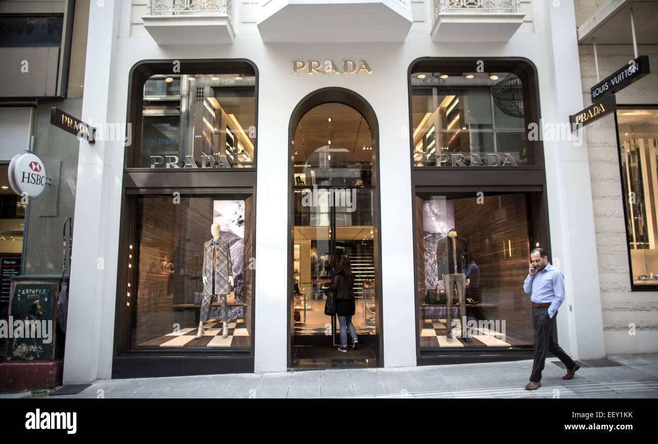 A woman enters a Prada shop for clothes and luxury goods in central ...