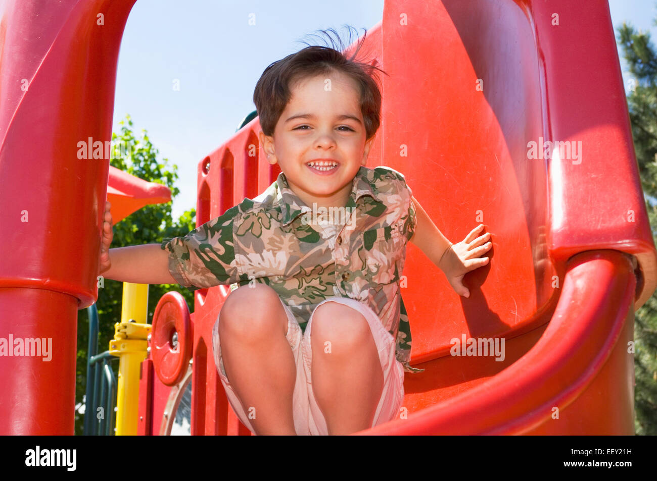 Young boy playing at playground Stock Photo - Alamy