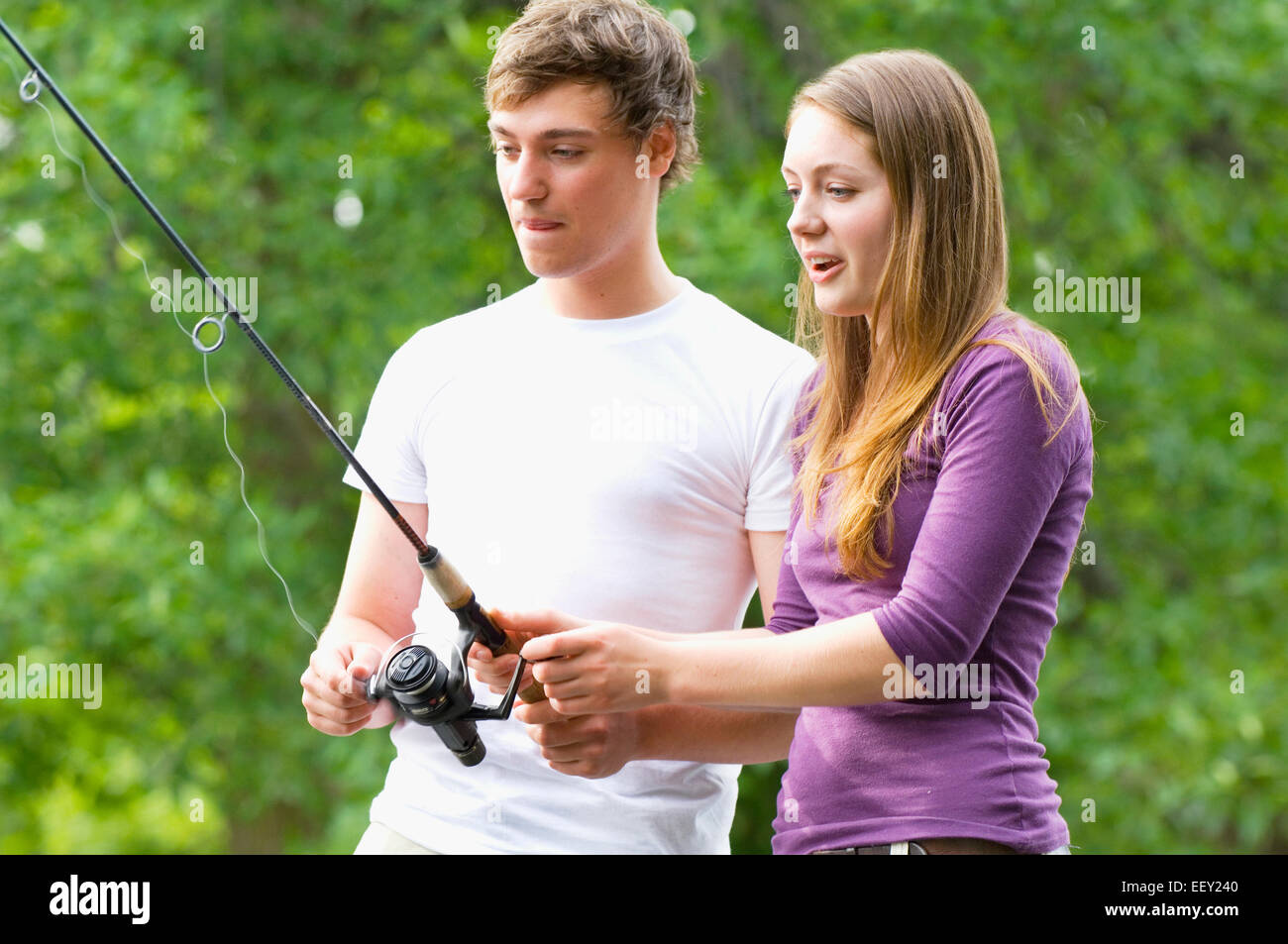 Two people fishing Stock Photo - Alamy
