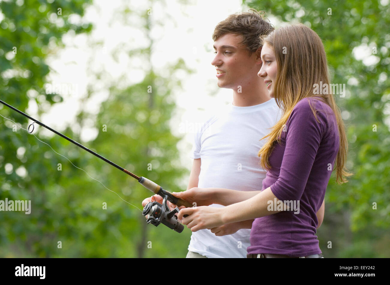 Two people fishing Stock Photo - Alamy