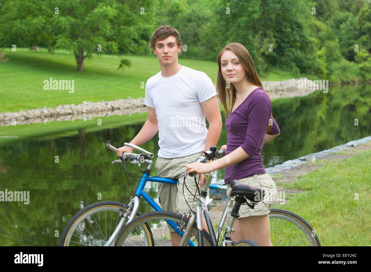 Two people at a park with bicycles Stock Photo - Alamy