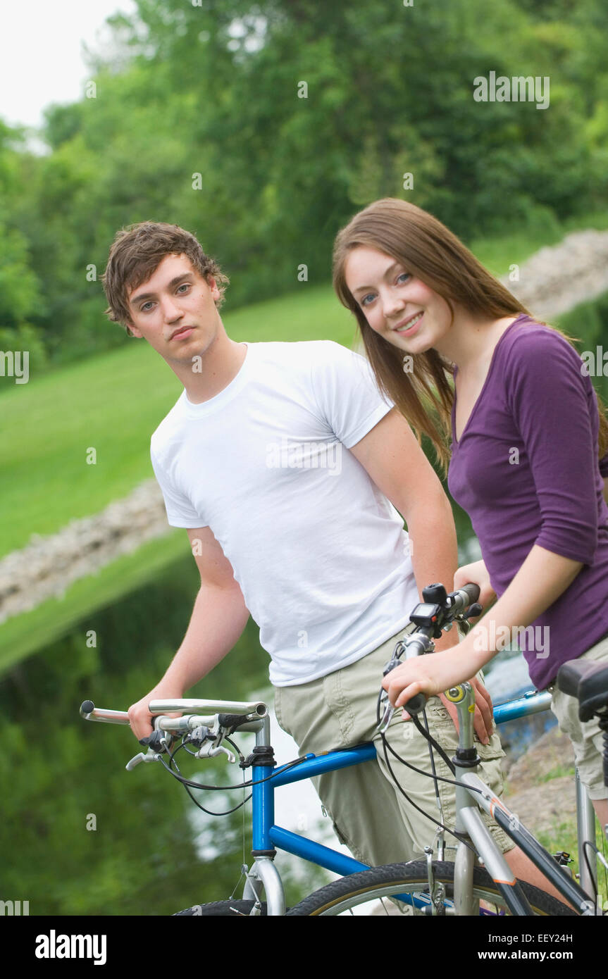 Two people at a park with bicycles Stock Photo - Alamy