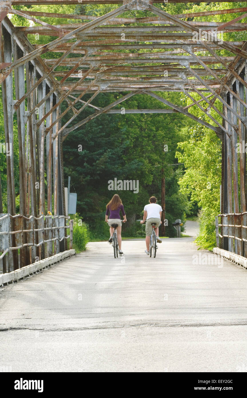 Two people on a bridge with bicycles Stock Photo - Alamy