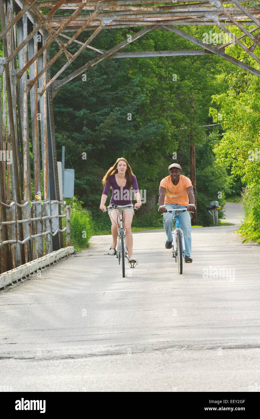 Two people on a bridge with bicycles Stock Photo - Alamy
