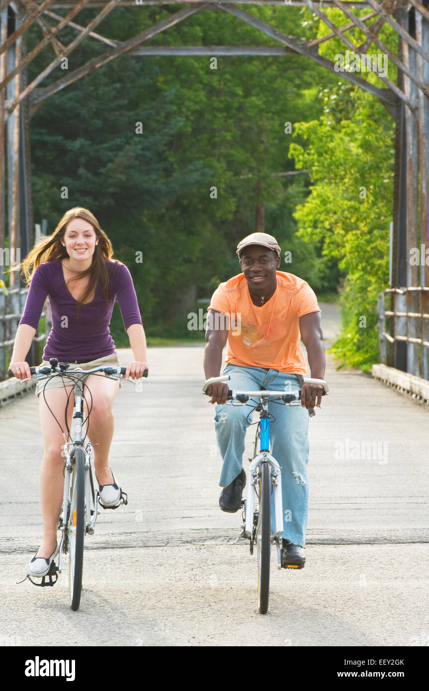 Two people on a bridge with bicycles Stock Photo - Alamy