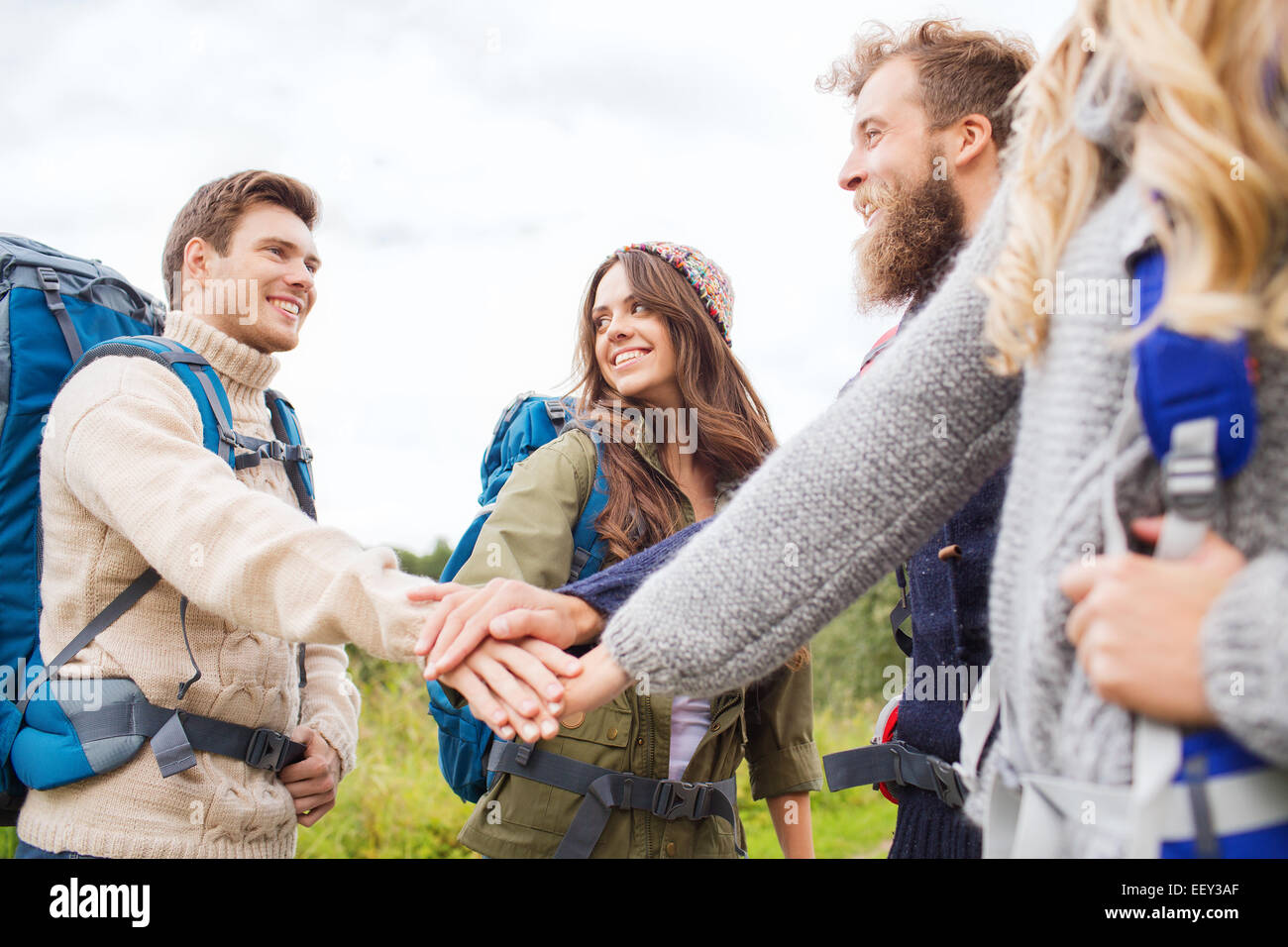 group of smiling friends with backpacks hiking Stock Photo - Alamy
