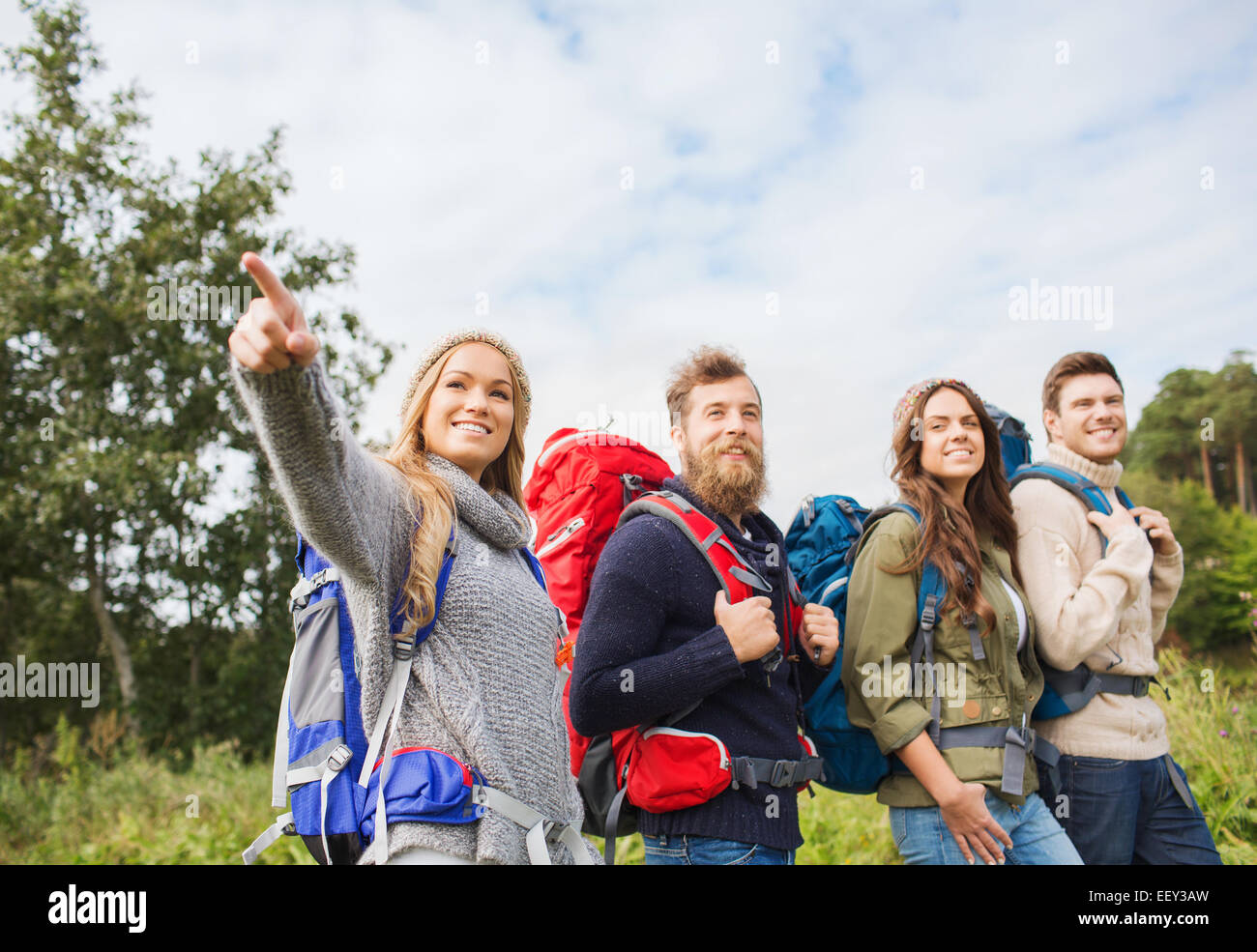 group of smiling friends with backpacks hiking Stock Photo - Alamy