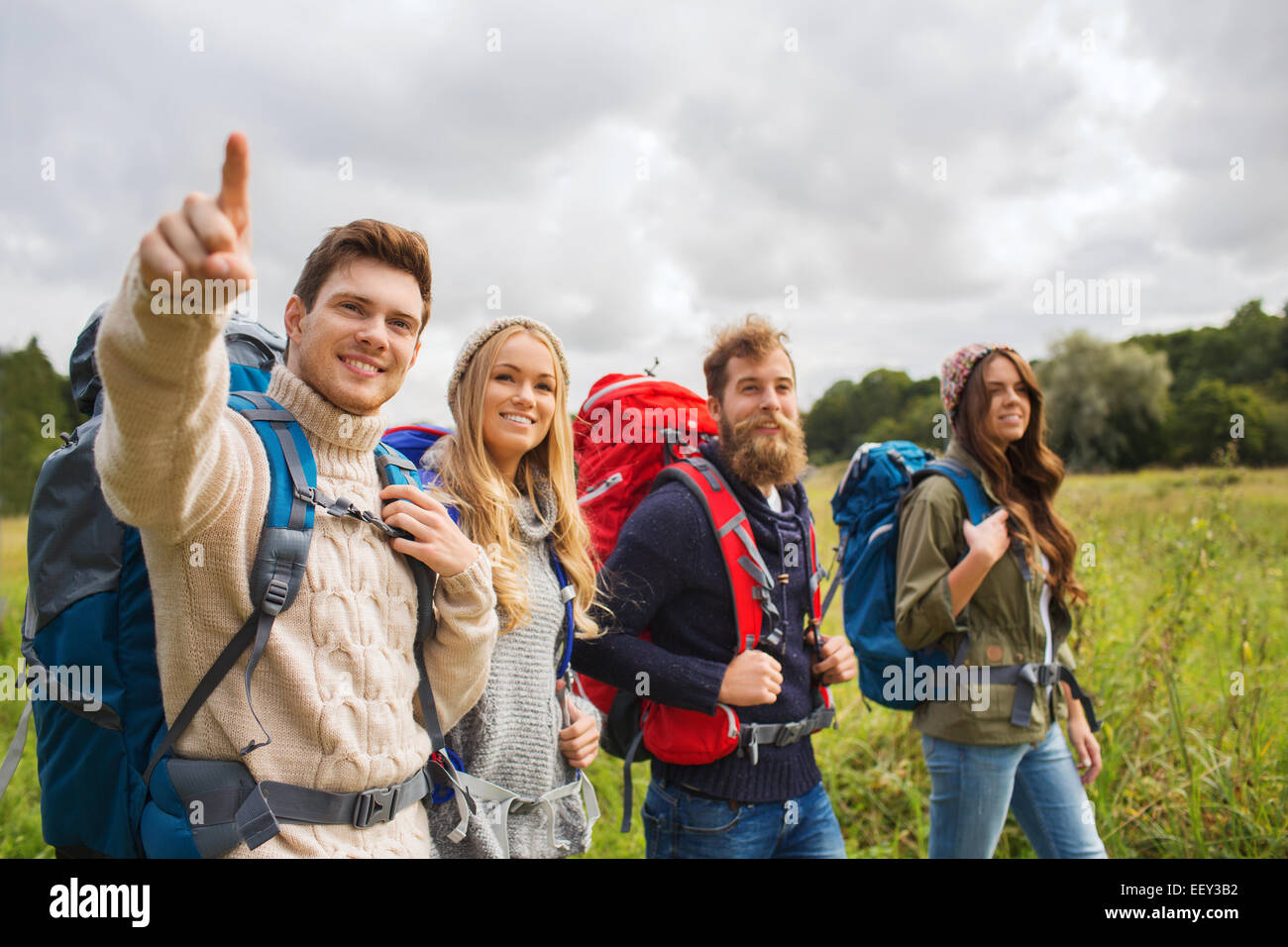 group of smiling friends with backpacks hiking Stock Photo - Alamy