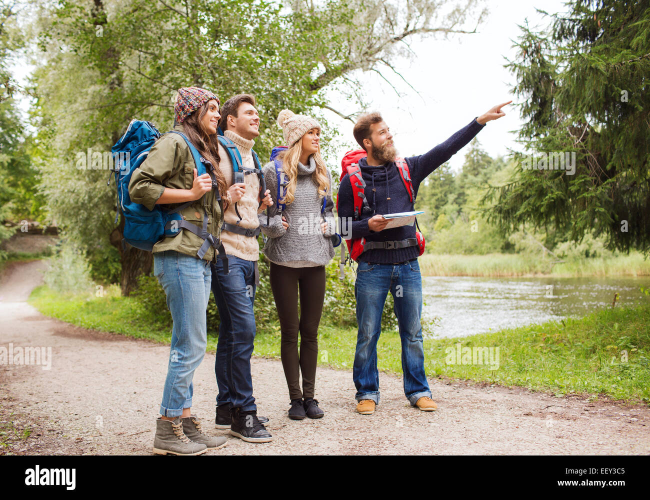 group of smiling friends with backpacks hiking Stock Photo - Alamy
