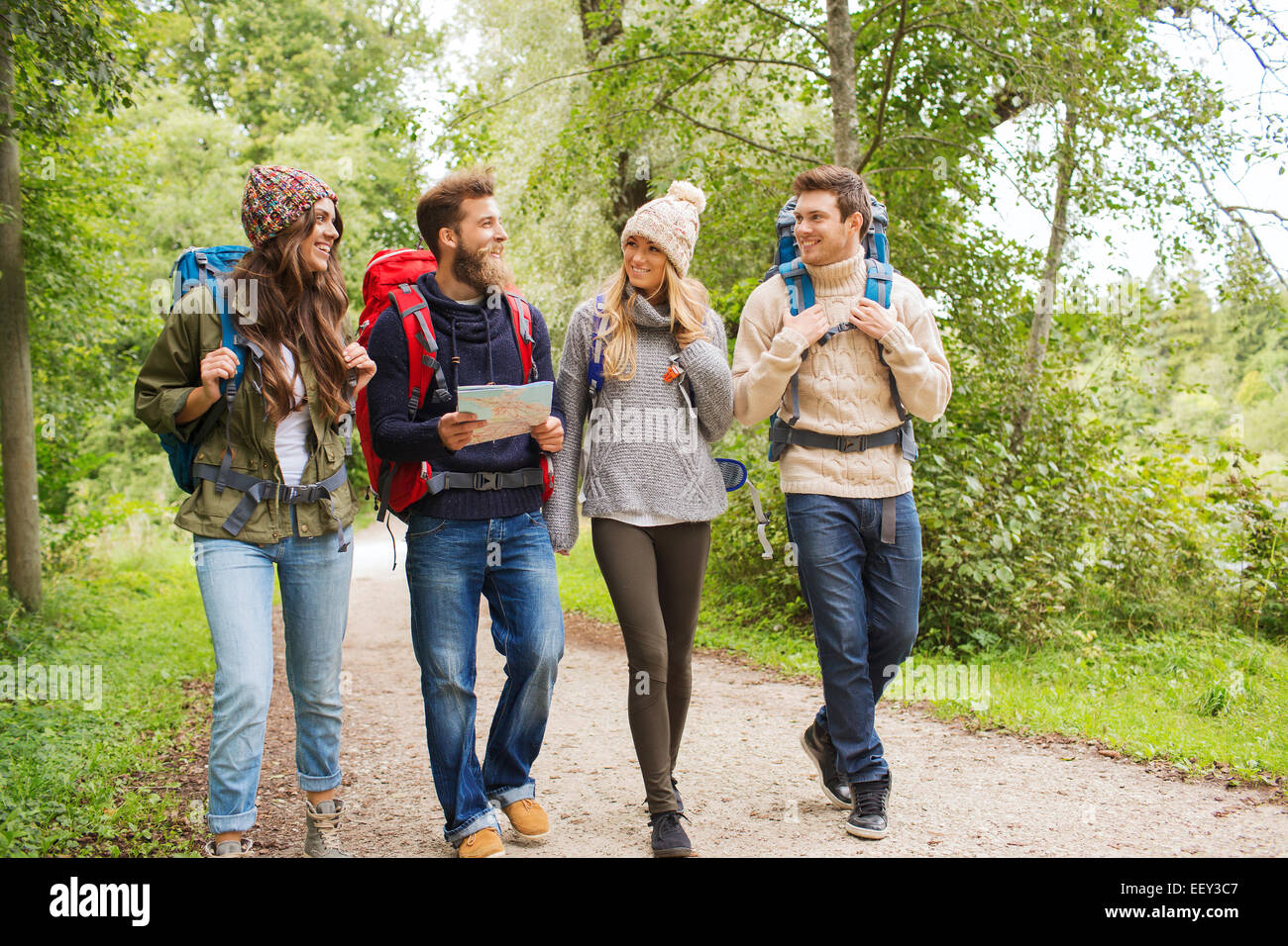 group of smiling friends with backpacks hiking Stock Photo - Alamy