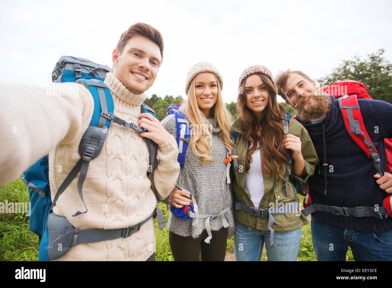 group of smiling friends with backpacks hiking Stock Photo - Alamy