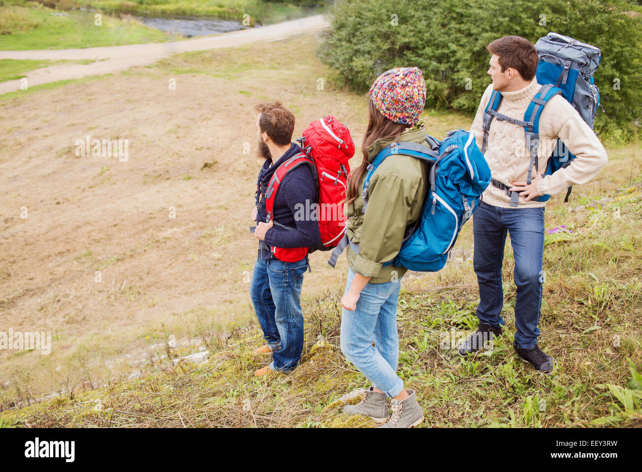 group of smiling friends with backpacks hiking Stock Photo - Alamy