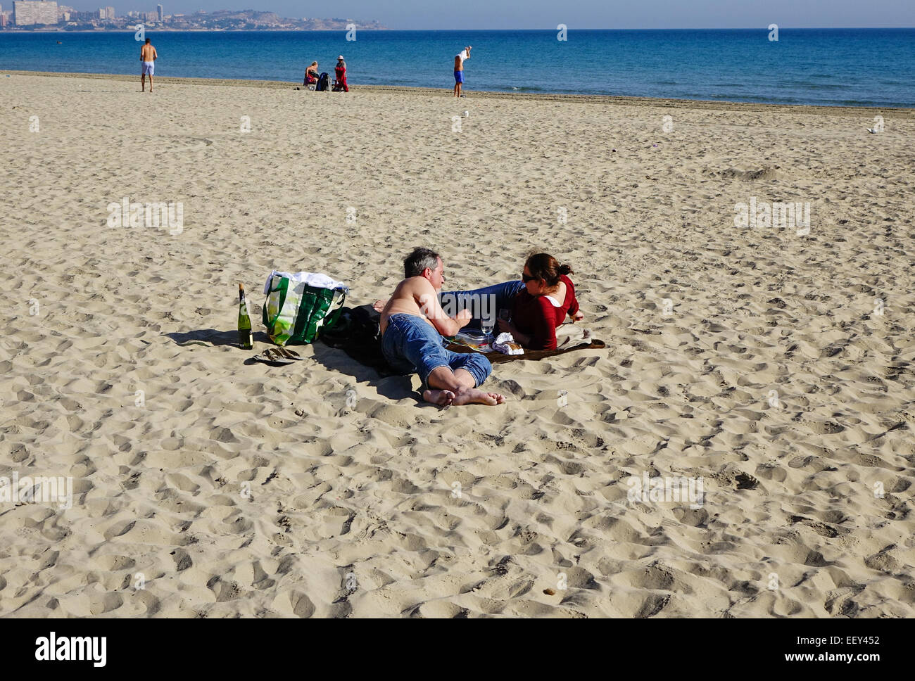 couple on the beach sunbathing Stock Photo - Alamy