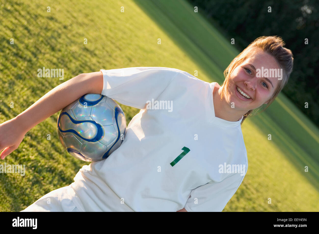 Girl on a soccer field Stock Photo - Alamy