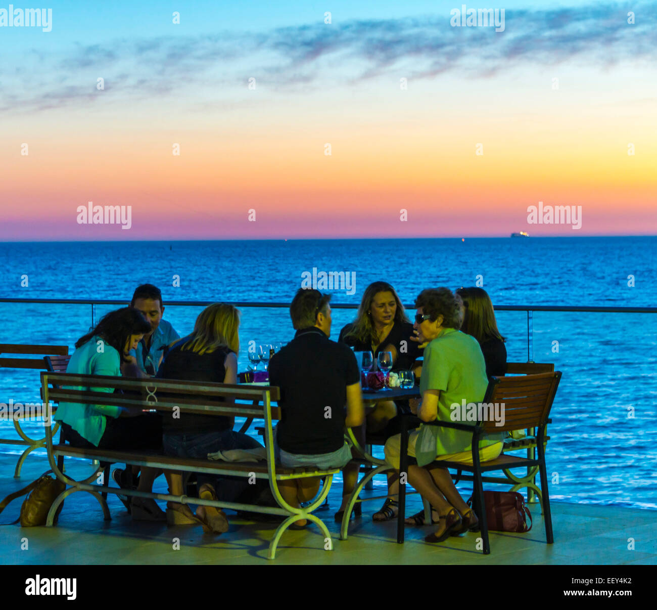 family gathering adults overlooking the ocean at sunset party all ages ...