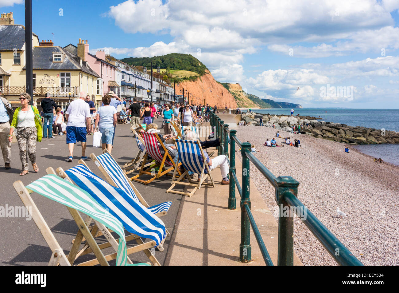 Seaside UK - people in deckchairs and on the promenade at Sidmouth ...