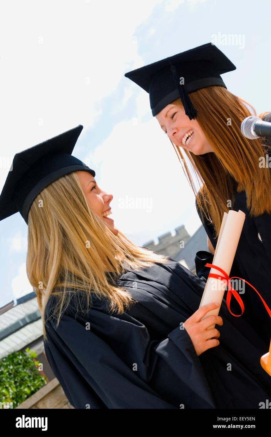 Two friends at podium on graduation day Stock Photo - Alamy